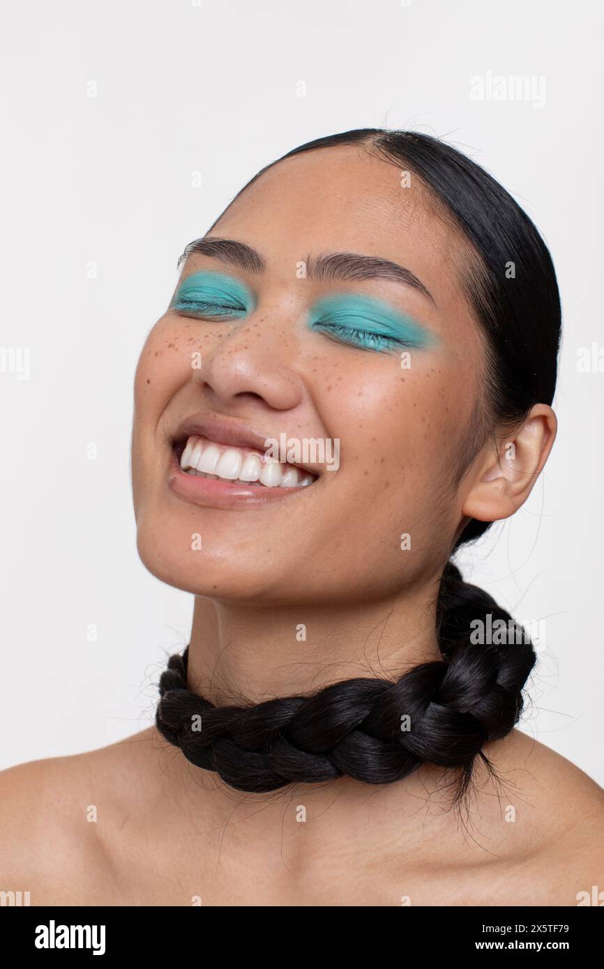 Portrait of smiling woman with black braid around neck Stock Photo - Alamy