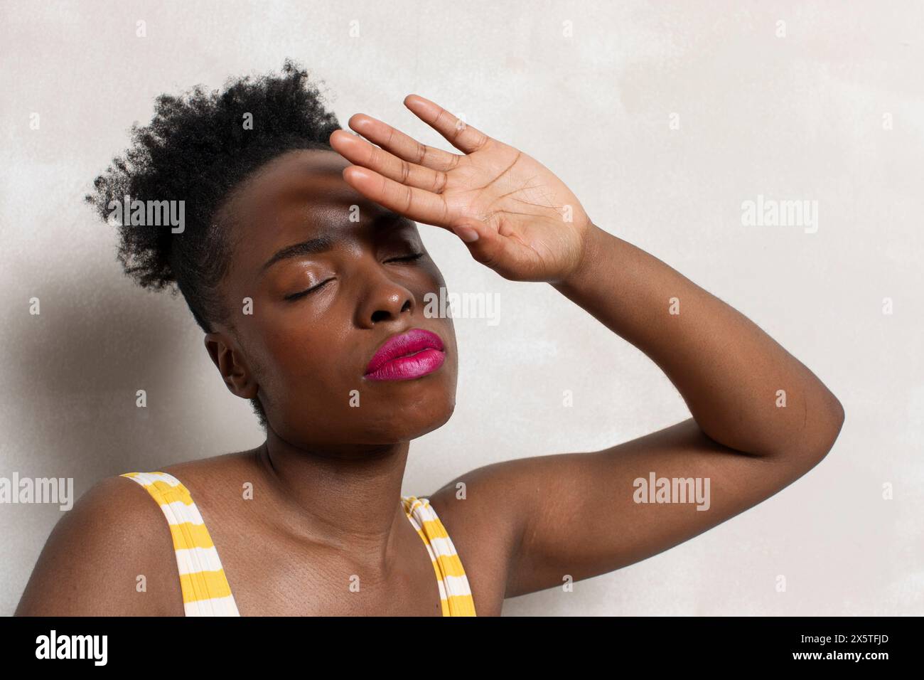 Woman with closed eyes shielding face with hand Stock Photo - Alamy