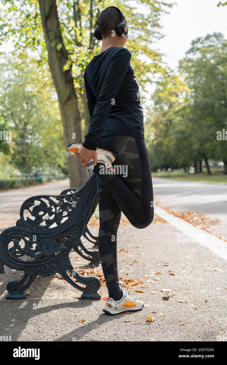 Woman stretching on park bench hi-res stock photography and images - Alamy