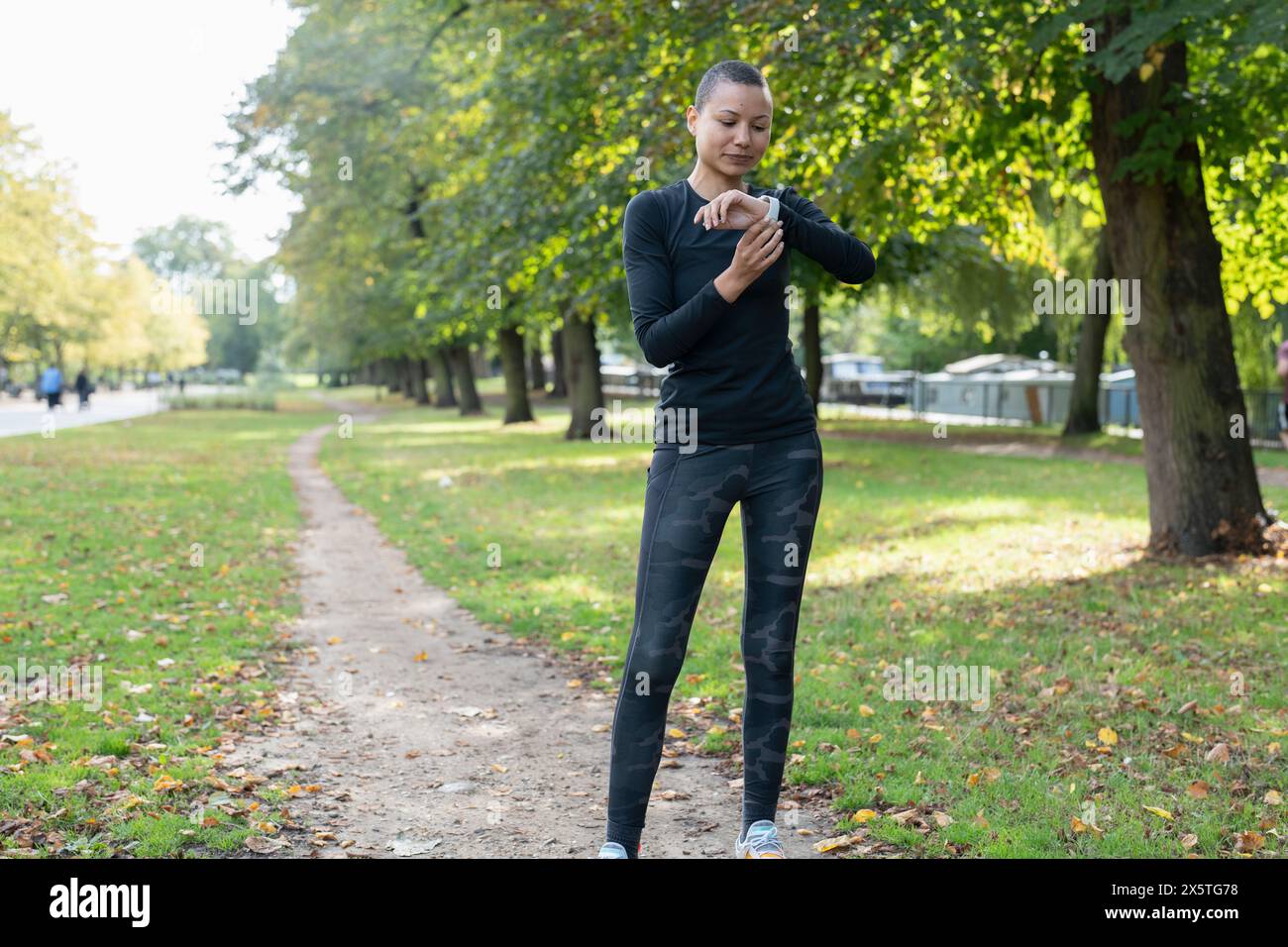 Black woman standing checking hi-res stock photography and images - Alamy
