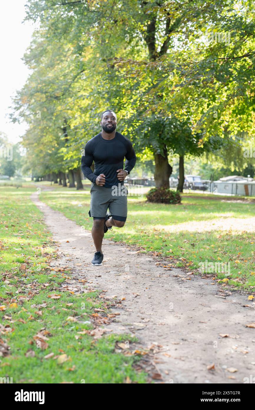 Muscular man jogging in park hi-res stock photography and images - Alamy