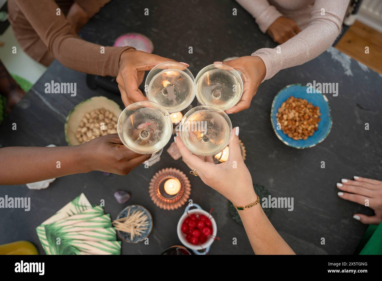 Female friends making celebratory toast Stock Photo - Alamy