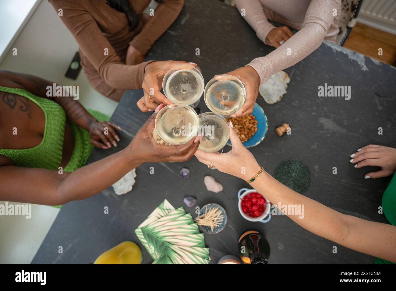 Female friends making celebratory toast Stock Photo - Alamy