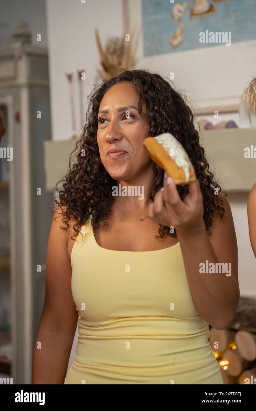 Beautiful woman eating cake Stock Photo - Alamy