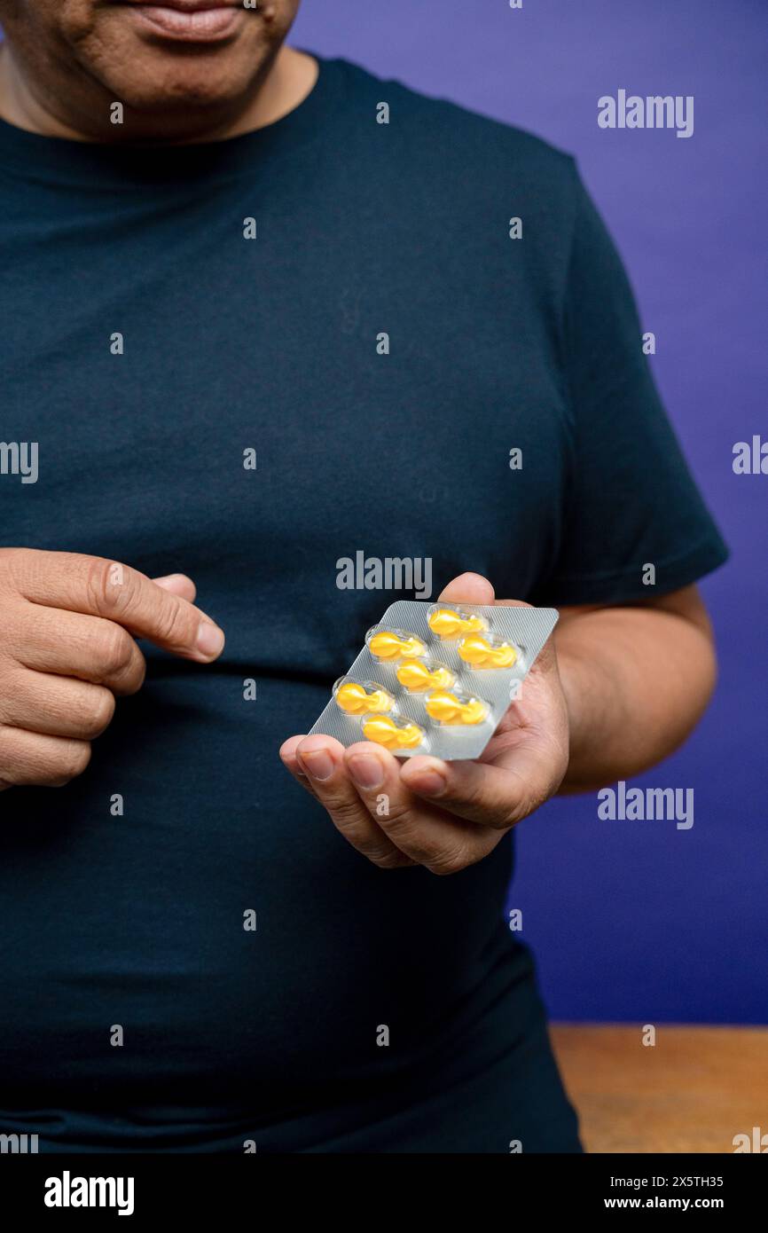 Man holding capsules vertical hi-res stock photography and images - Alamy