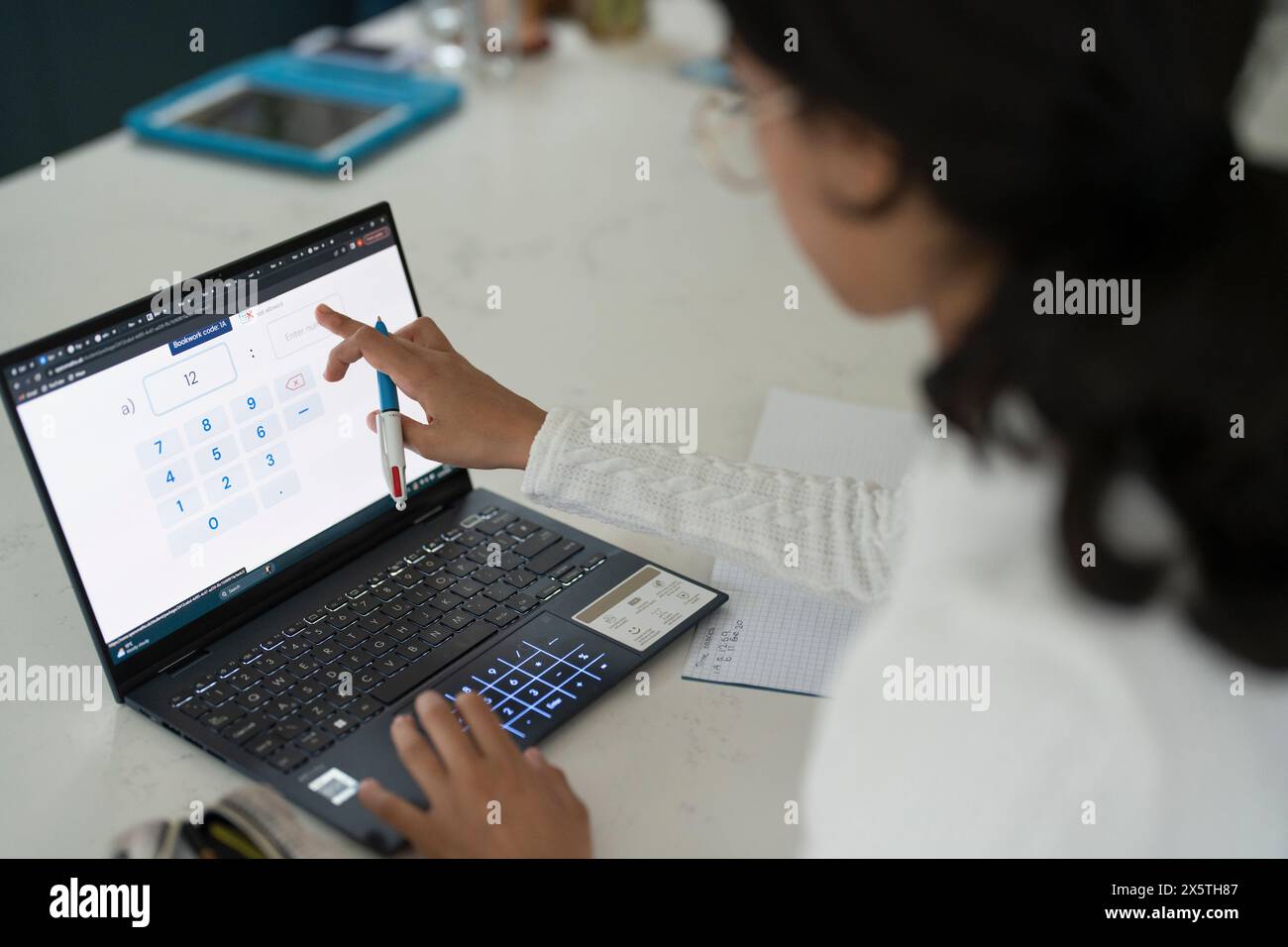 Using laptop and calculator hi-res stock photography and images - Alamy