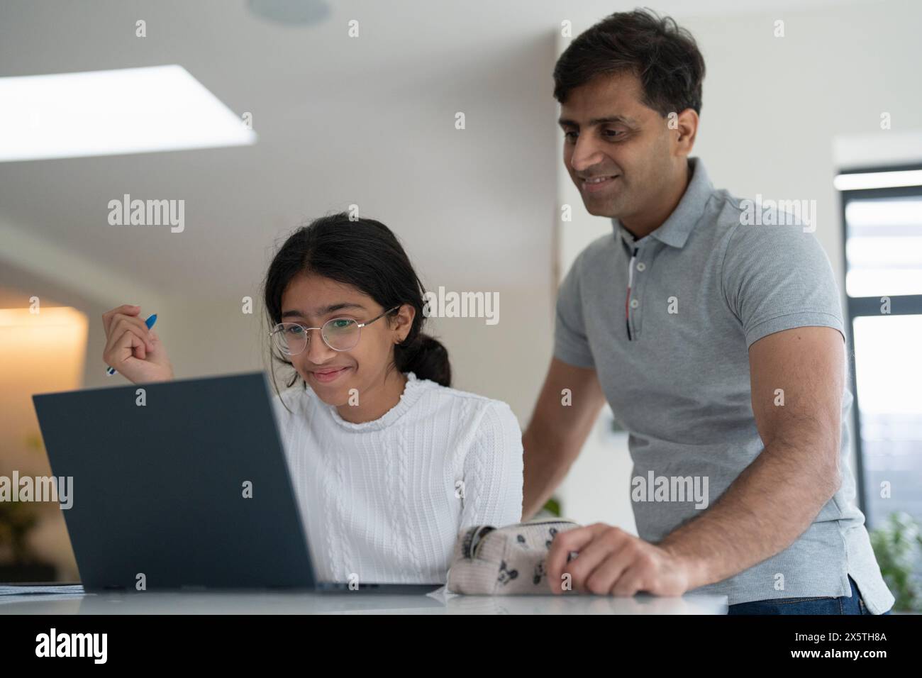 Father helping daughter doing homework Stock Photo - Alamy