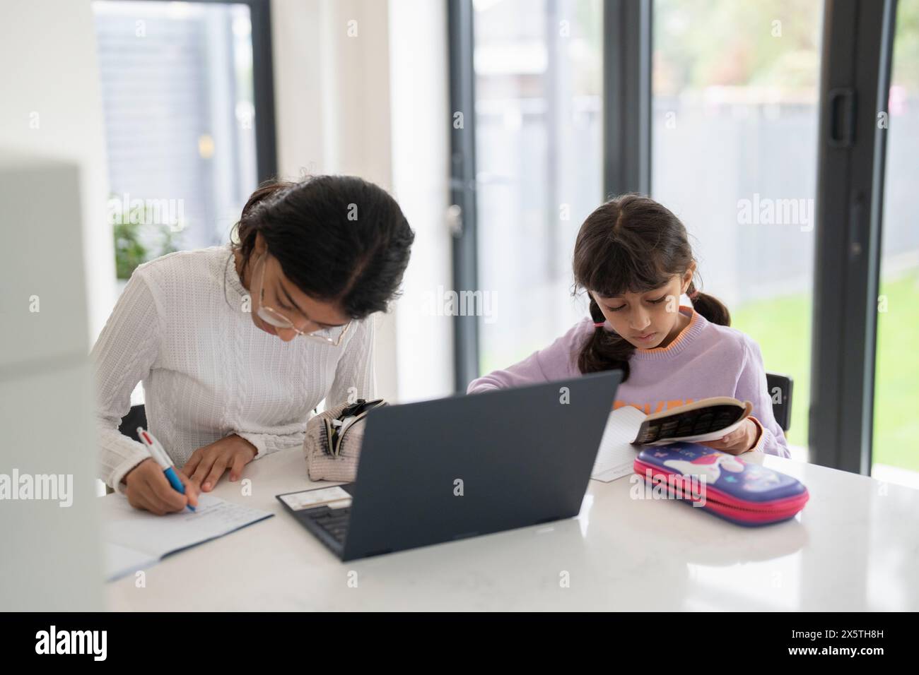 Two sisters doing homework together Stock Photo - Alamy