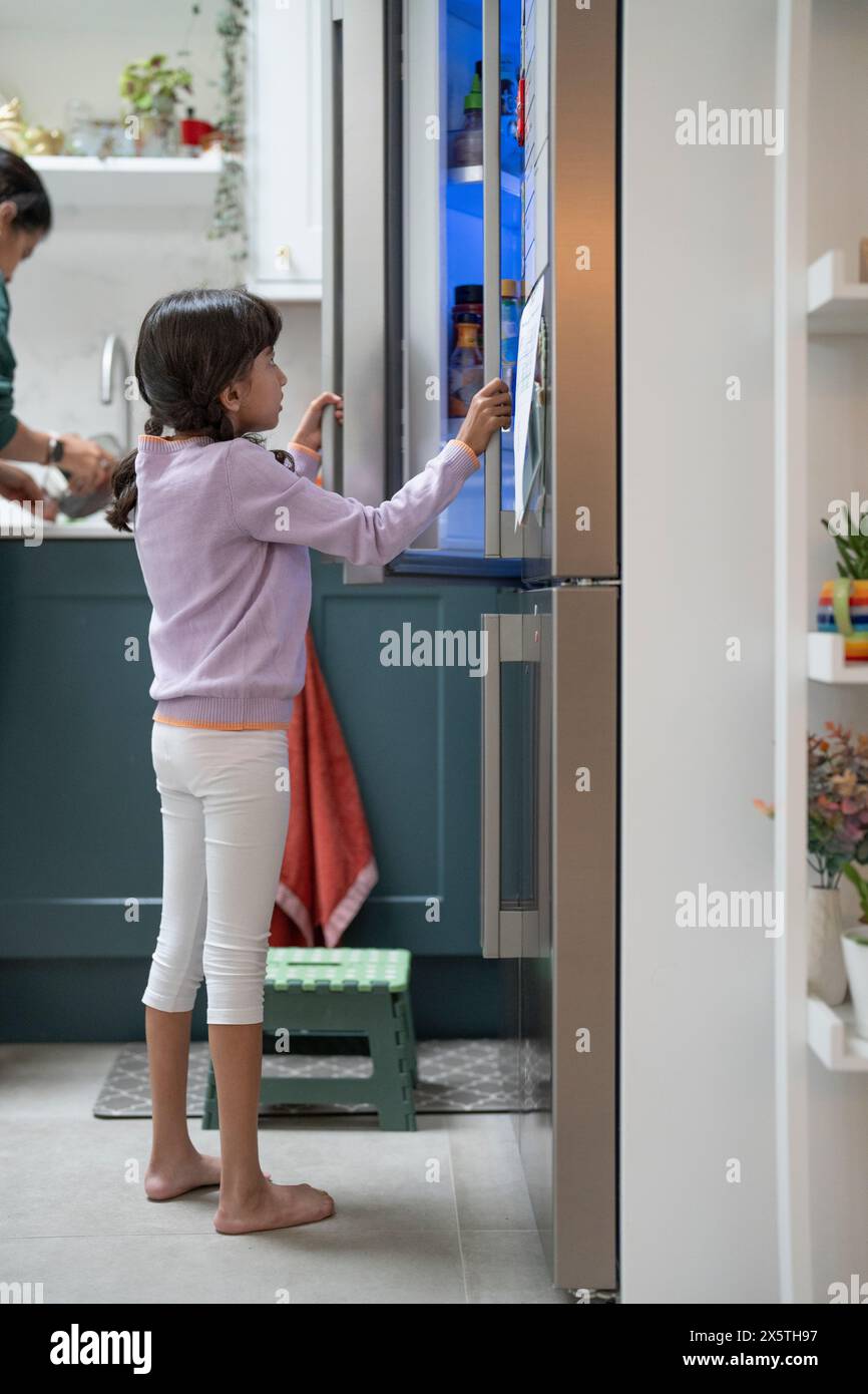 Little girl opening fridge Stock Photo - Alamy