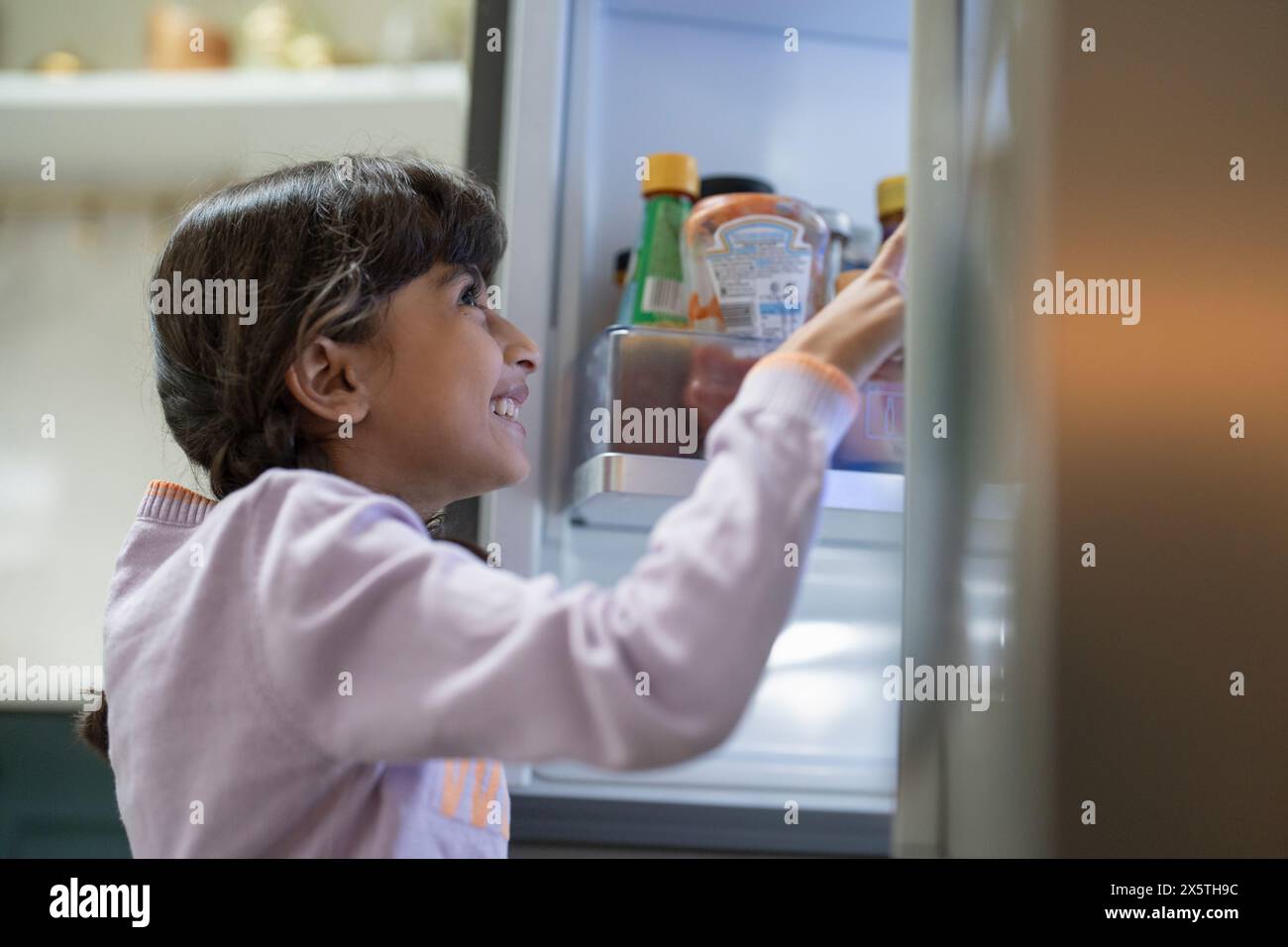 Little girl opening fridge Stock Photo - Alamy