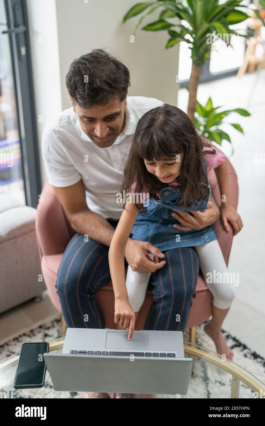 Father using laptop sitting hi-res stock photography and images - Alamy