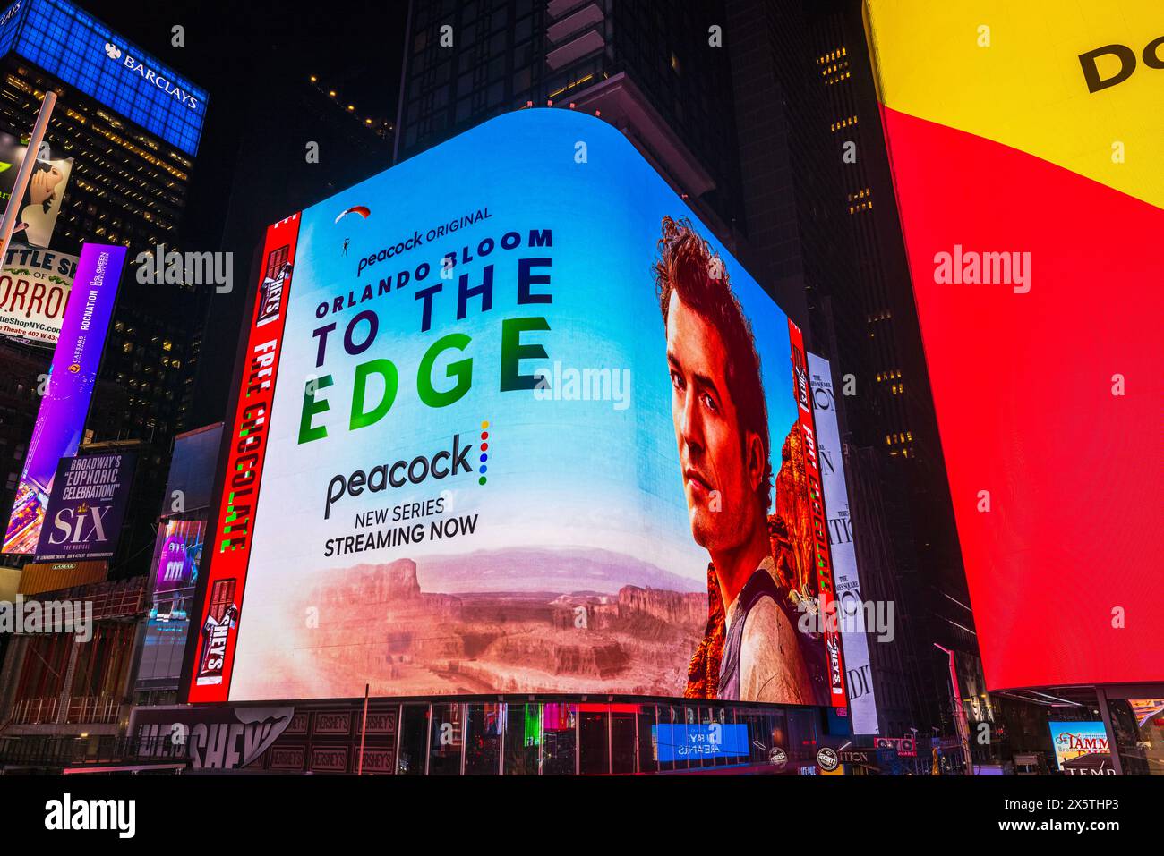 Beautiful view of Times Square on Broadway at night with illuminated neon advertisements on ...