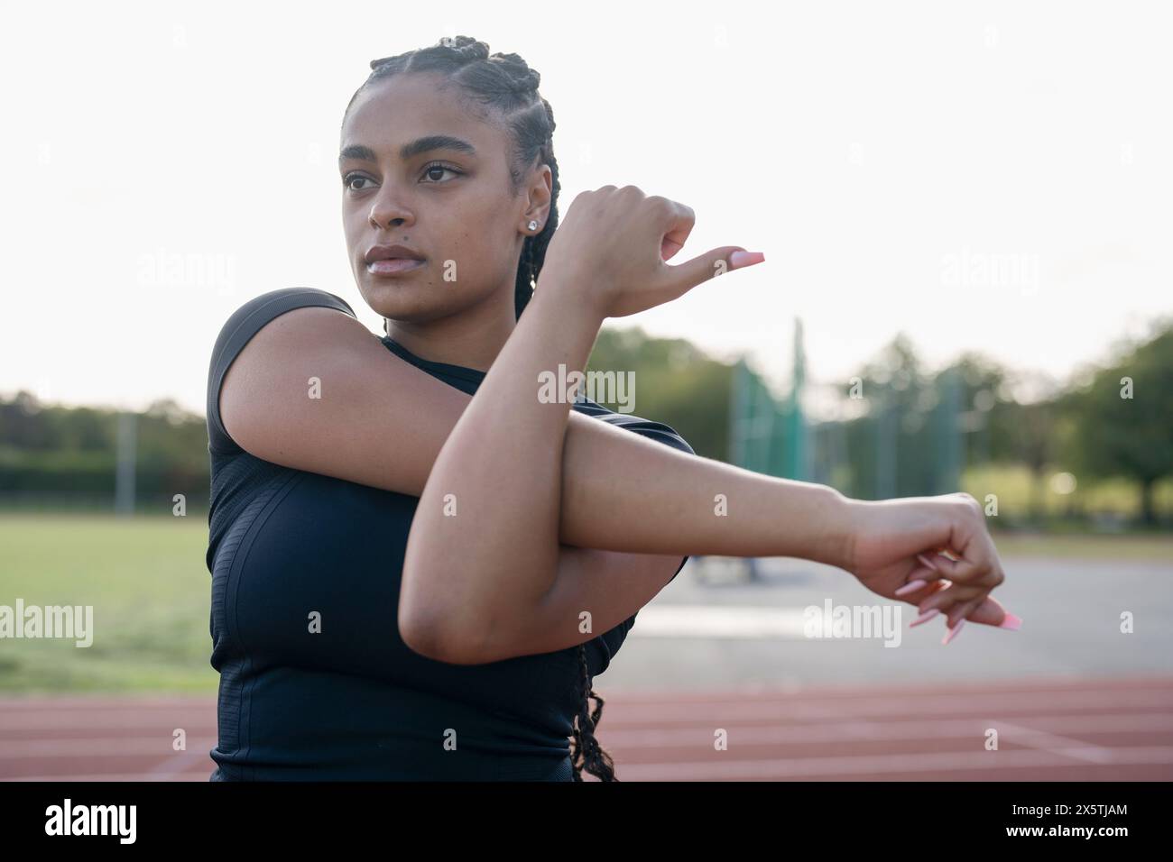 Female athlete stretching arms before training Stock Photo - Alamy