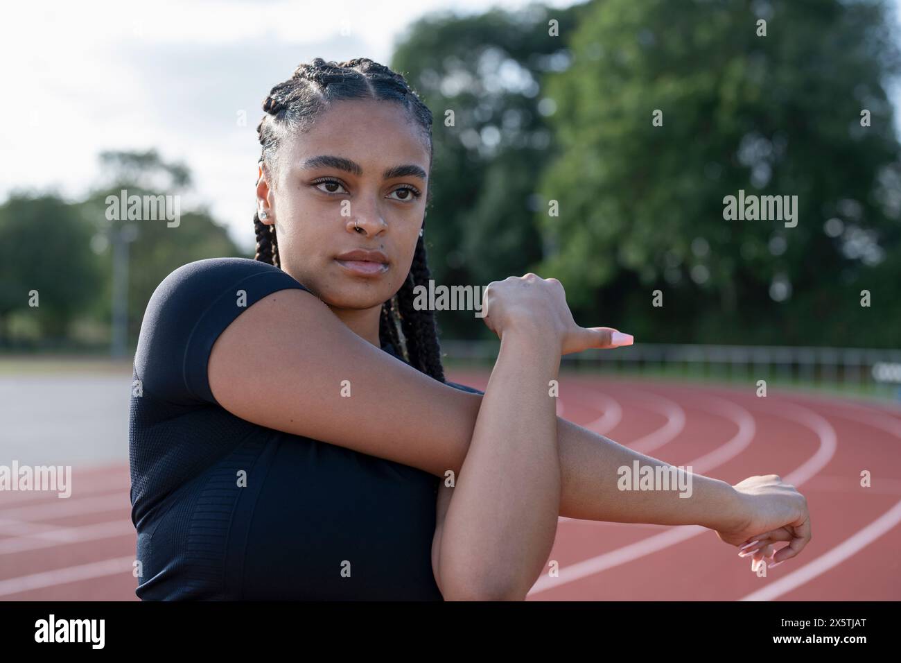 Female athlete stretching arms before training Stock Photo - Alamy
