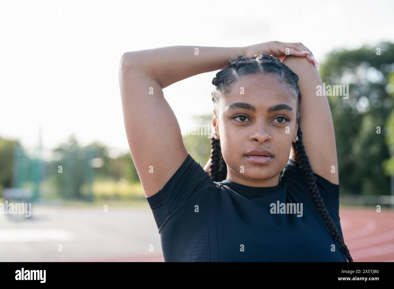 Female athlete stretching arms before training Stock Photo - Alamy