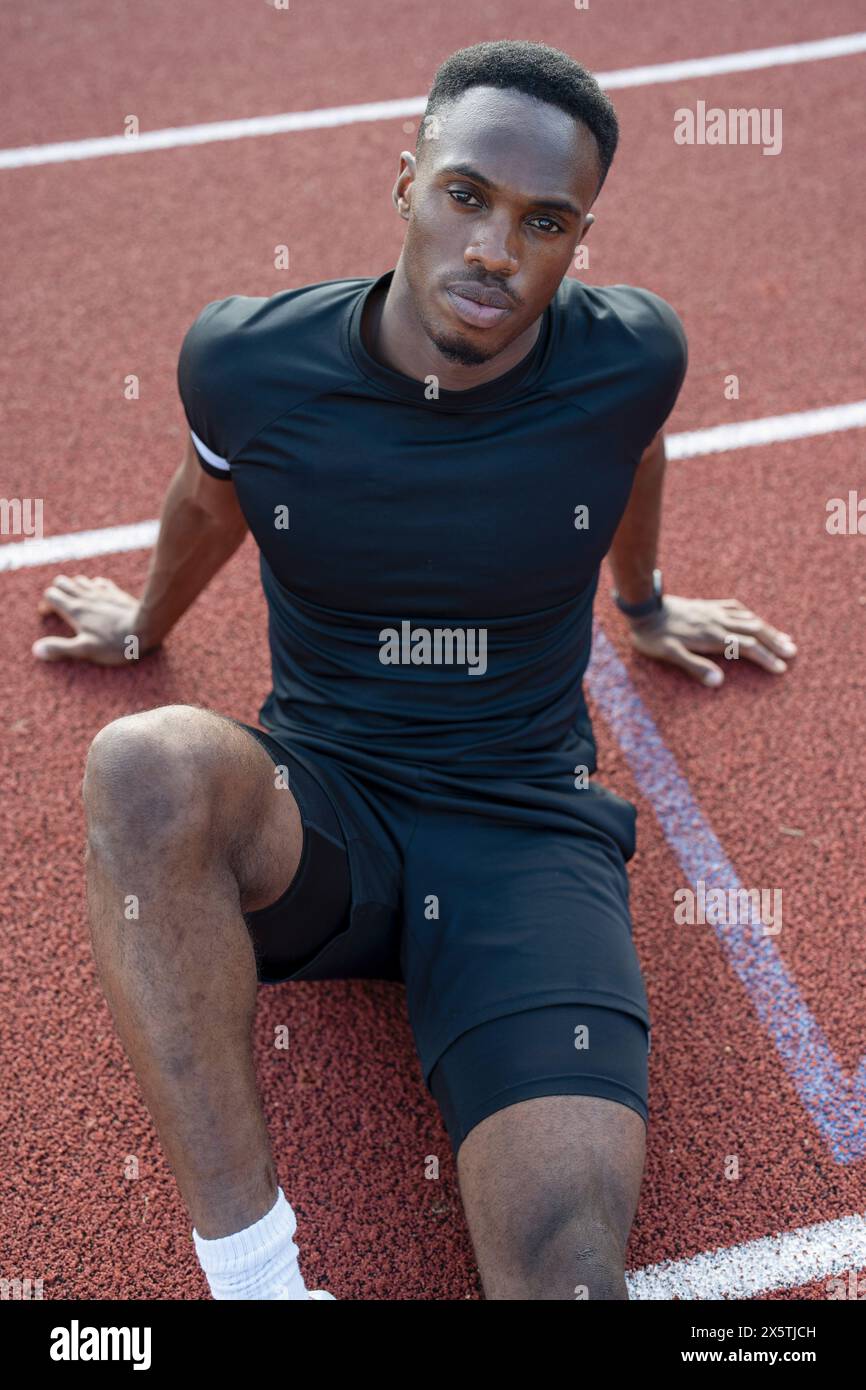 Young man sitting track hi-res stock photography and images - Alamy