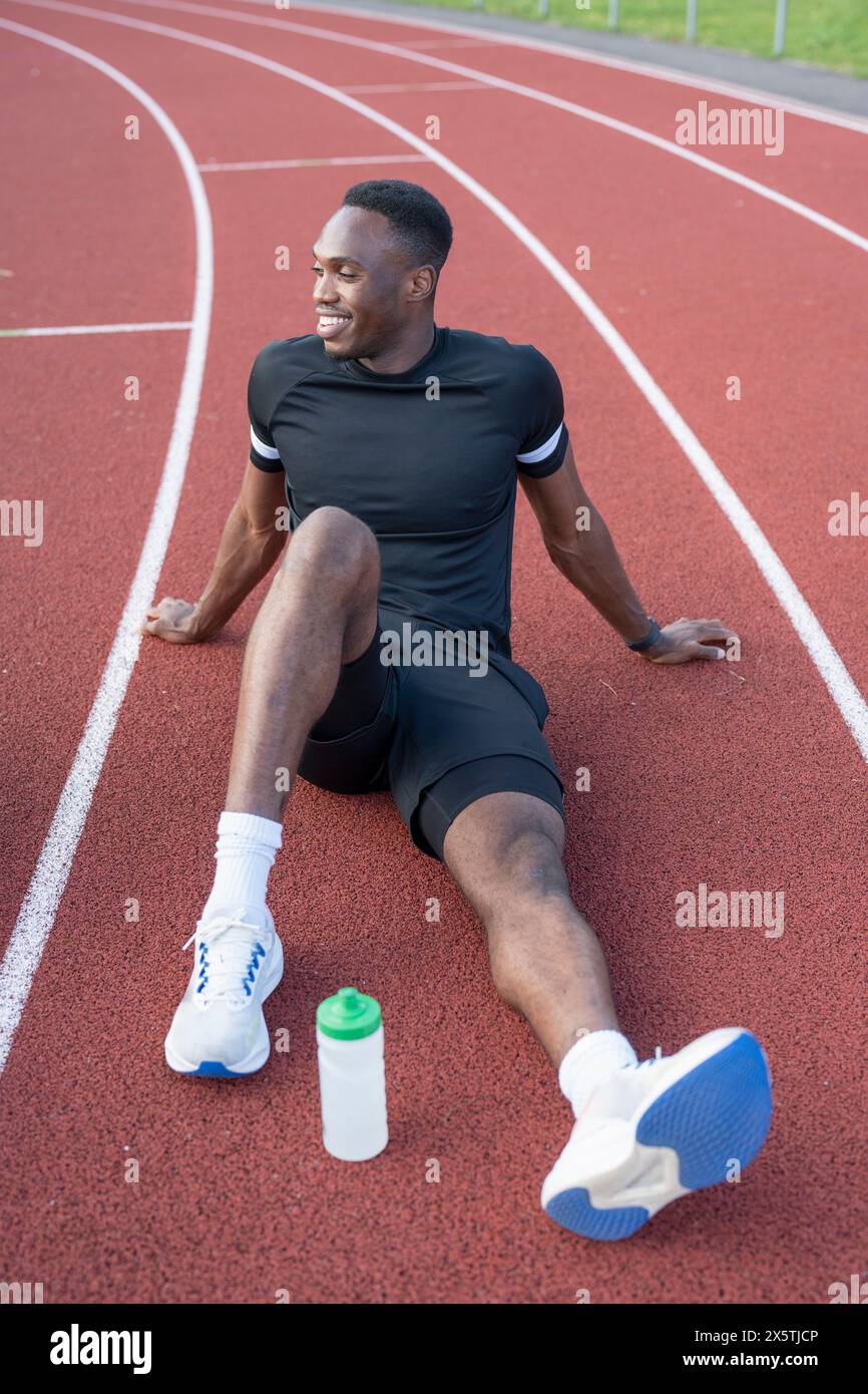 Athlete resting at sports track after training Stock Photo - Alamy