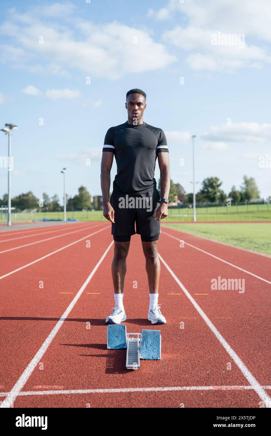 Athlete standing in front of starting line at stadium Stock Photo - Alamy