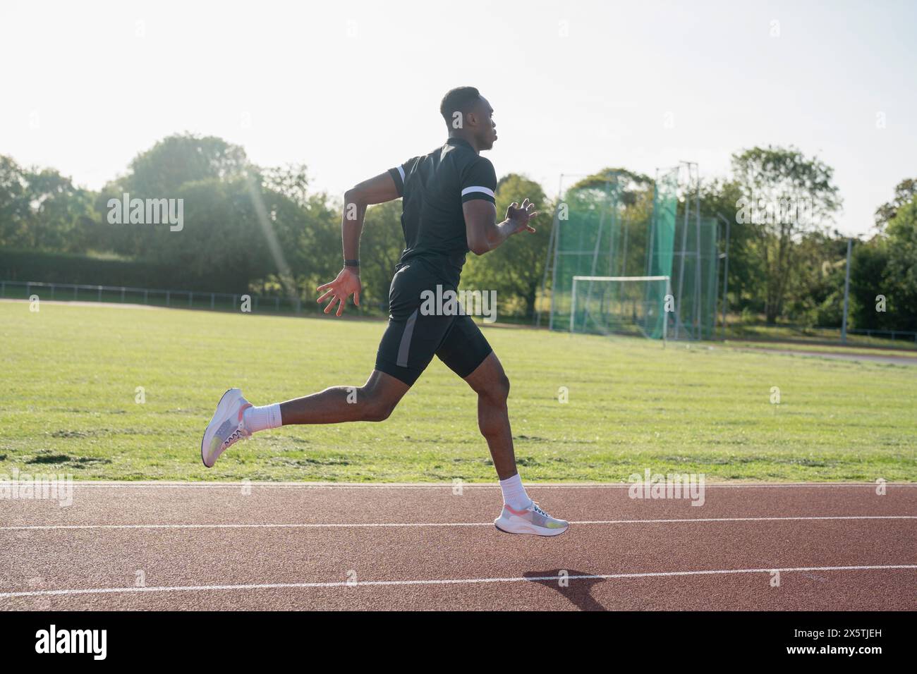 Athlete sprinting at running track Stock Photo - Alamy