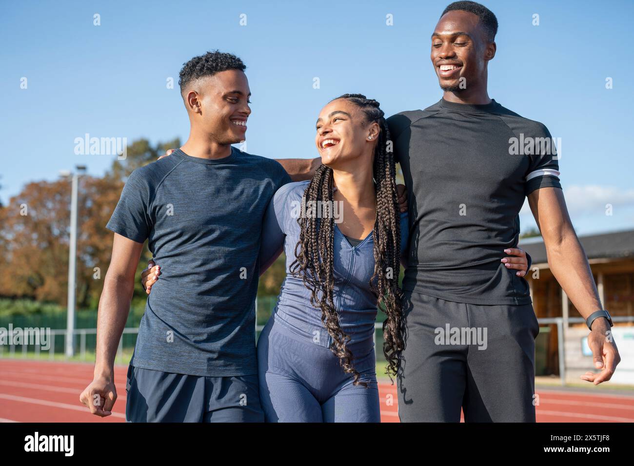 Portrait of group of athletes standing at stadium Stock Photo - Alamy