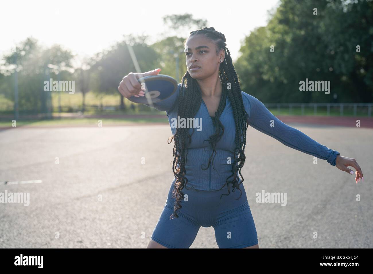 Female athlete training discus throwing at stadium Stock Photo - Alamy