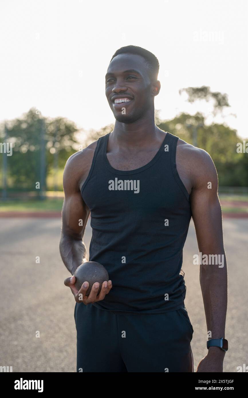 Portrait of athlete holding shot put Stock Photo - Alamy