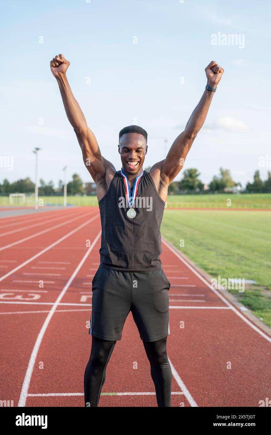 Portrait of athlete celebrating with medal Stock Photo - Alamy