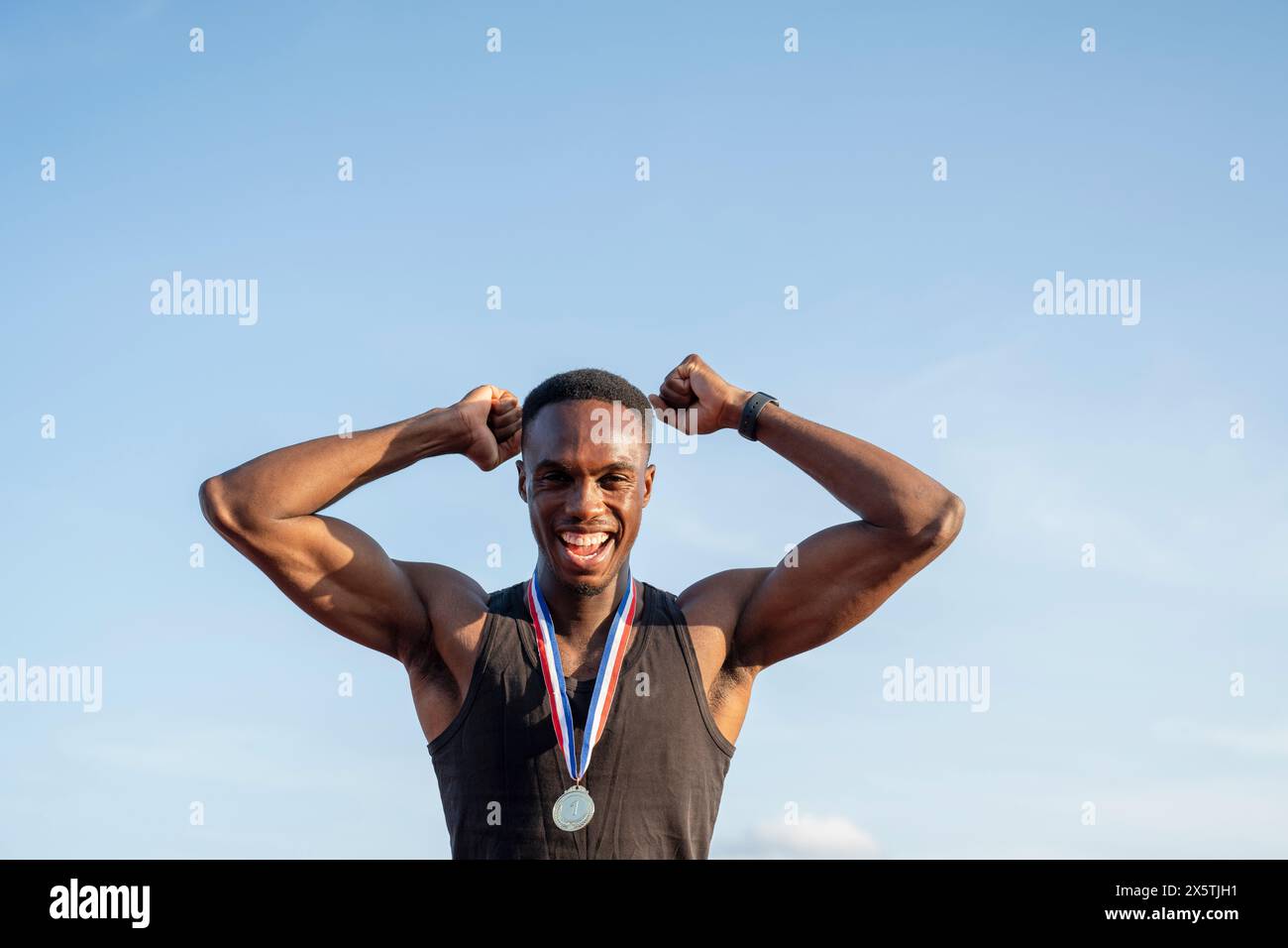Portrait of athlete celebrating with medal Stock Photo - Alamy