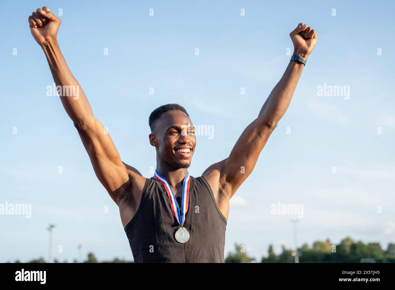 Portrait of athlete celebrating with medal Stock Photo - Alamy