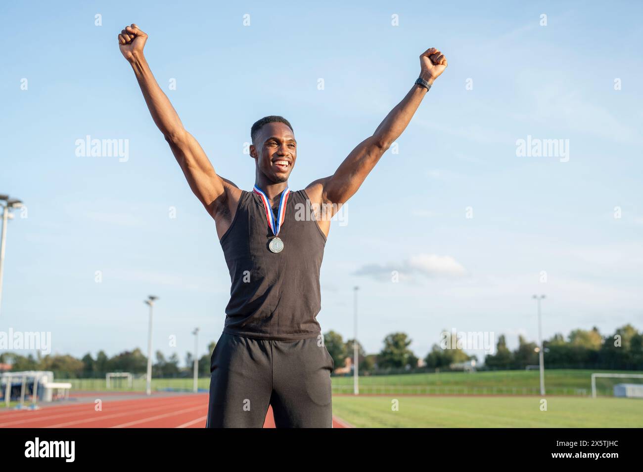 Portrait of athlete celebrating with medal Stock Photo - Alamy