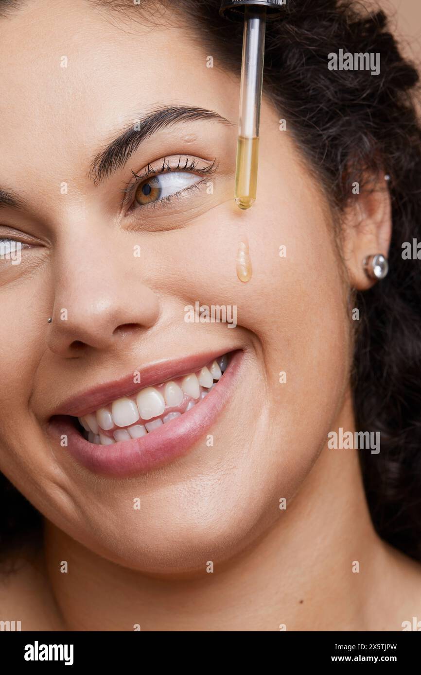 Young woman applying face hi-res stock photography and images - Alamy