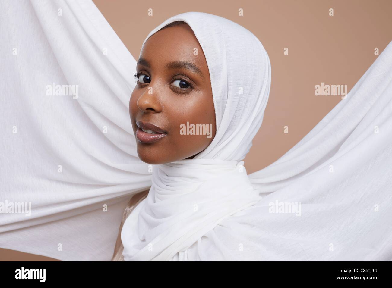 Young woman in beige hijab hi-res stock photography and images - Alamy