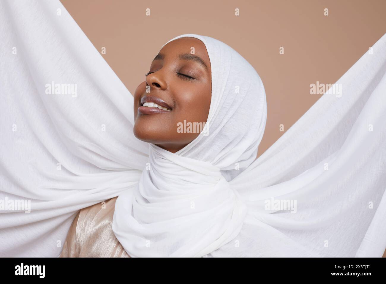 Young woman in beige hijab hi-res stock photography and images - Alamy
