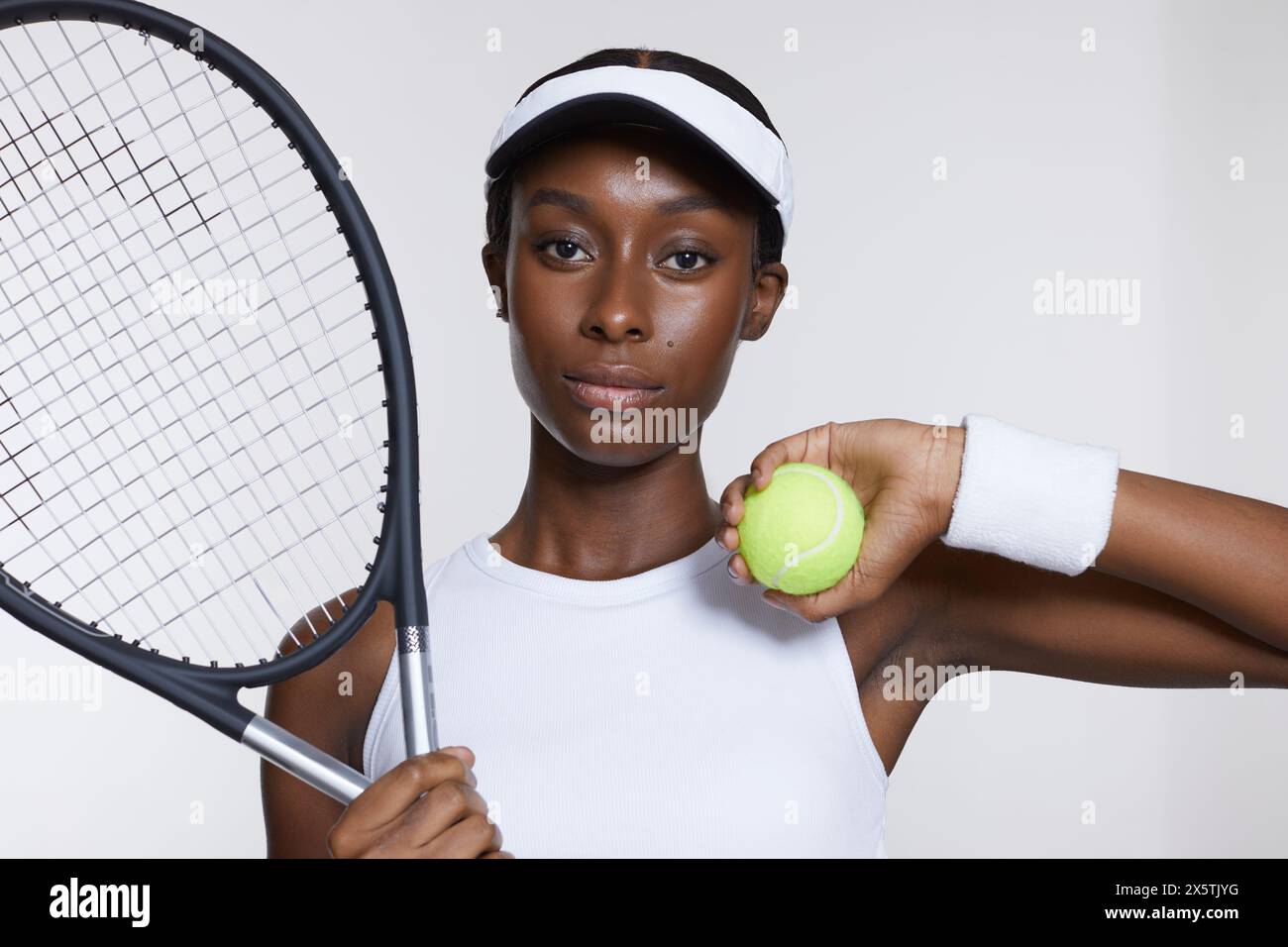 Studio portrait of athletic woman with tennis racket and ball Stock ...