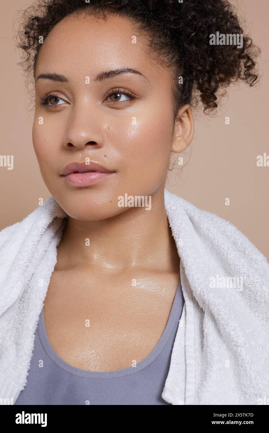 Studio portrait of athletic woman with towel around neck Stock Photo ...