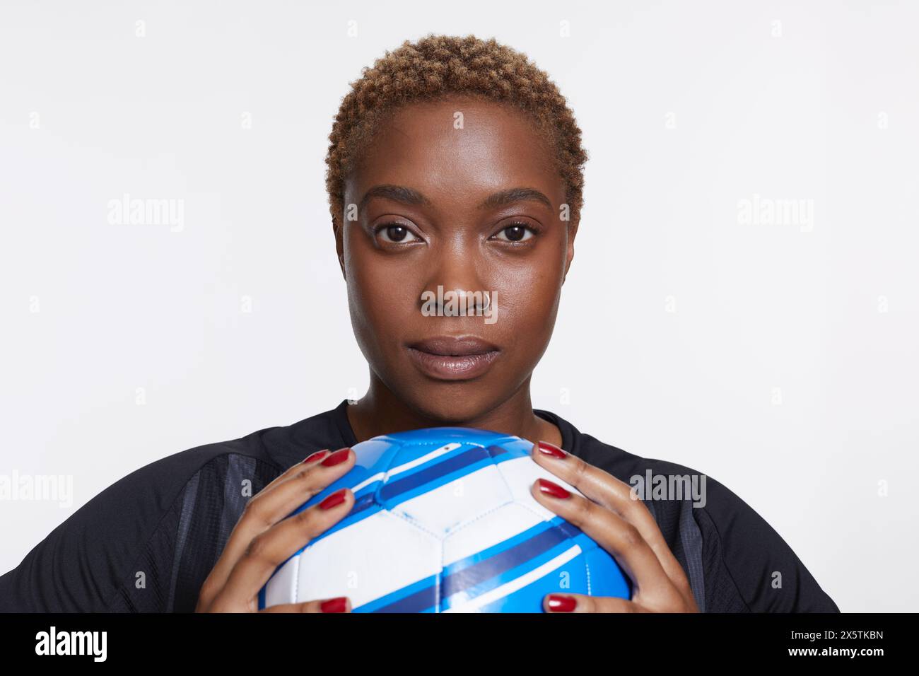 Studio portrait of female soccer player with ball Stock Photo - Alamy
