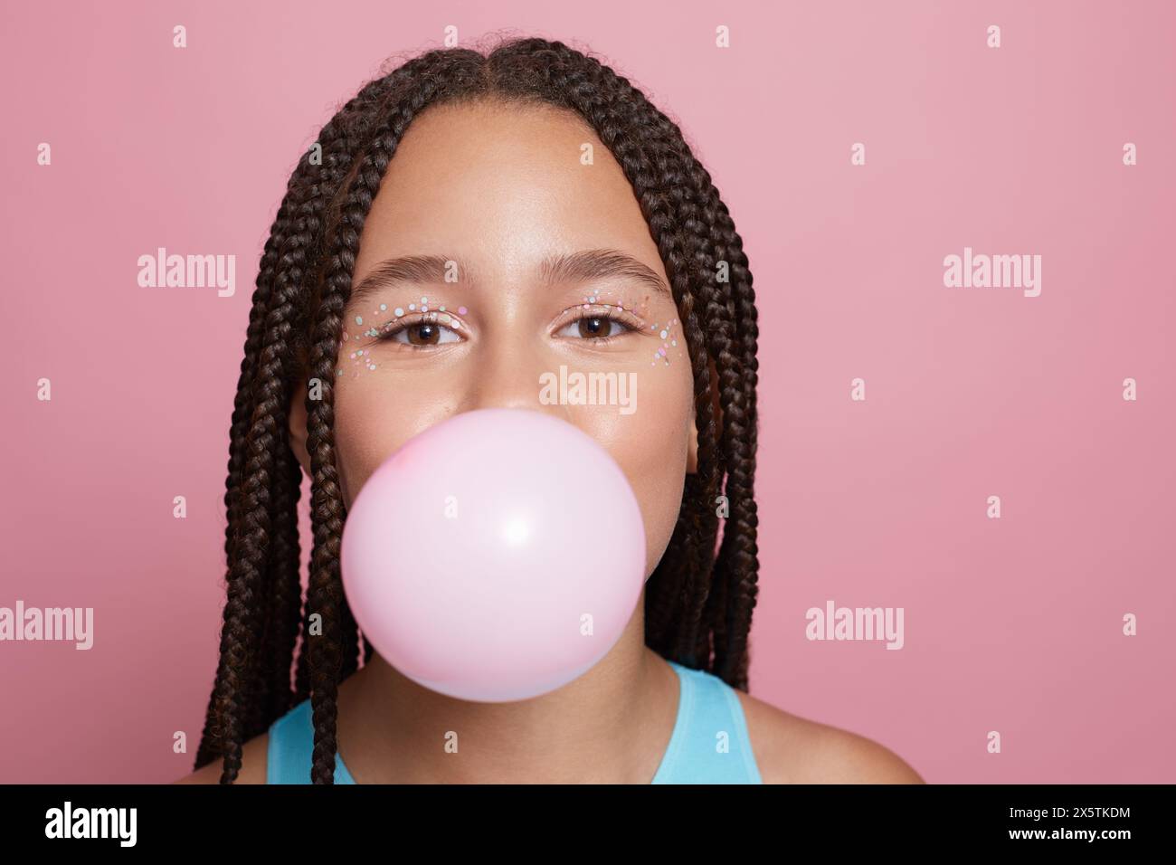 Studio portrait of girl blowing bubble gum Stock Photo - Alamy