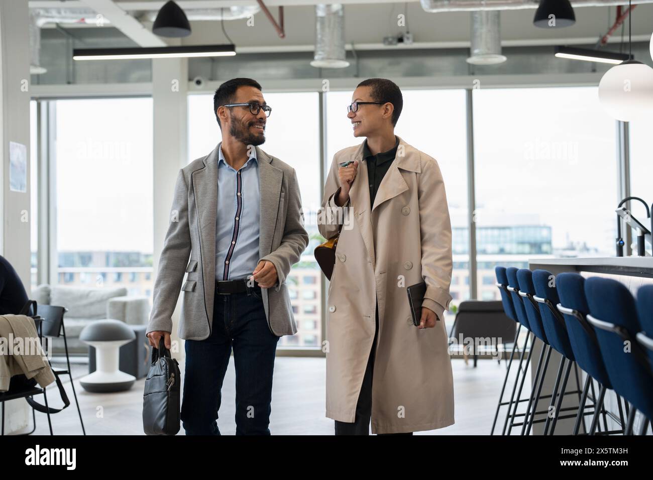 Office workers walking together in hallway Stock Photo - Alamy