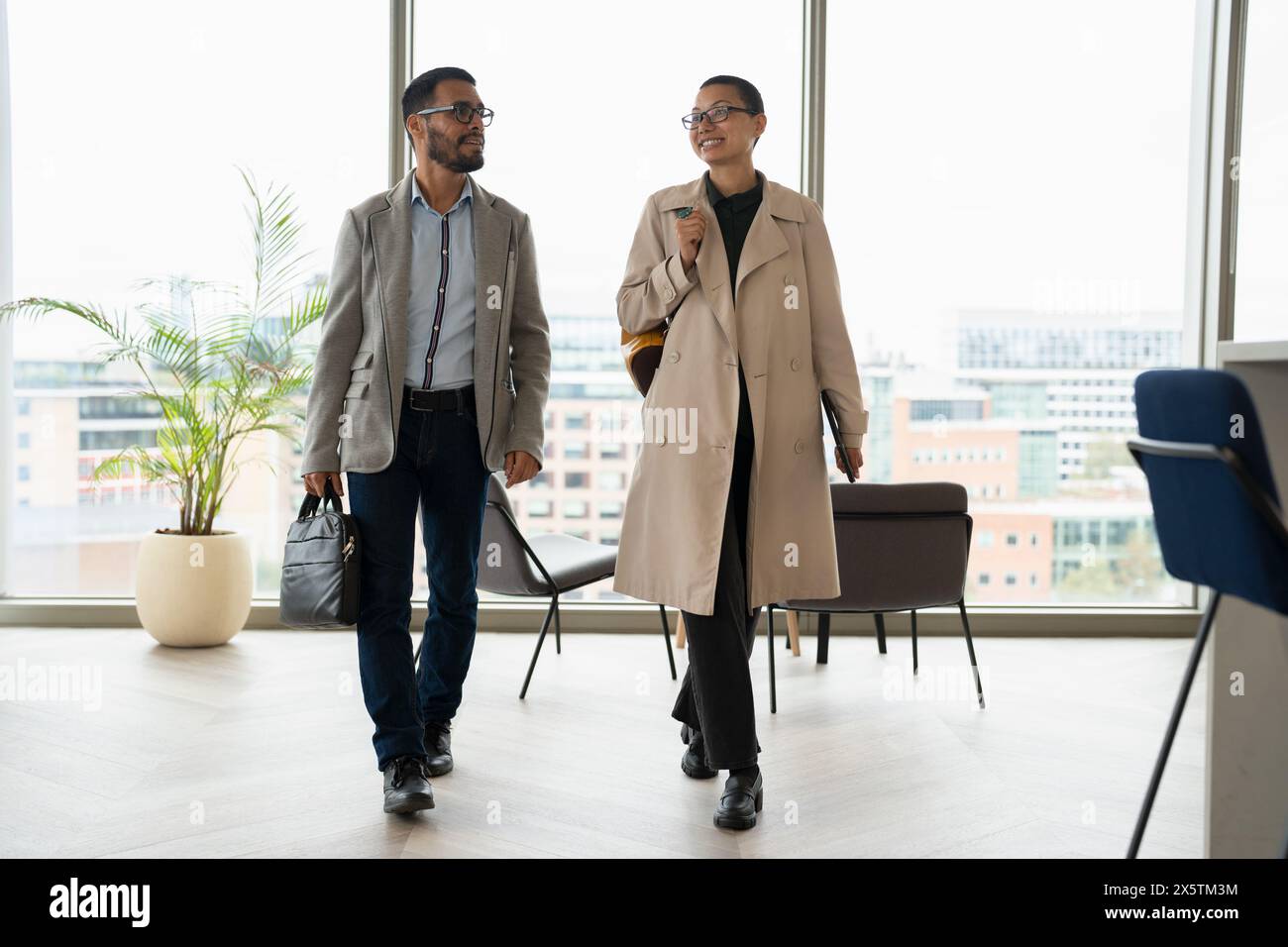 Office workers walking together in hallway Stock Photo - Alamy