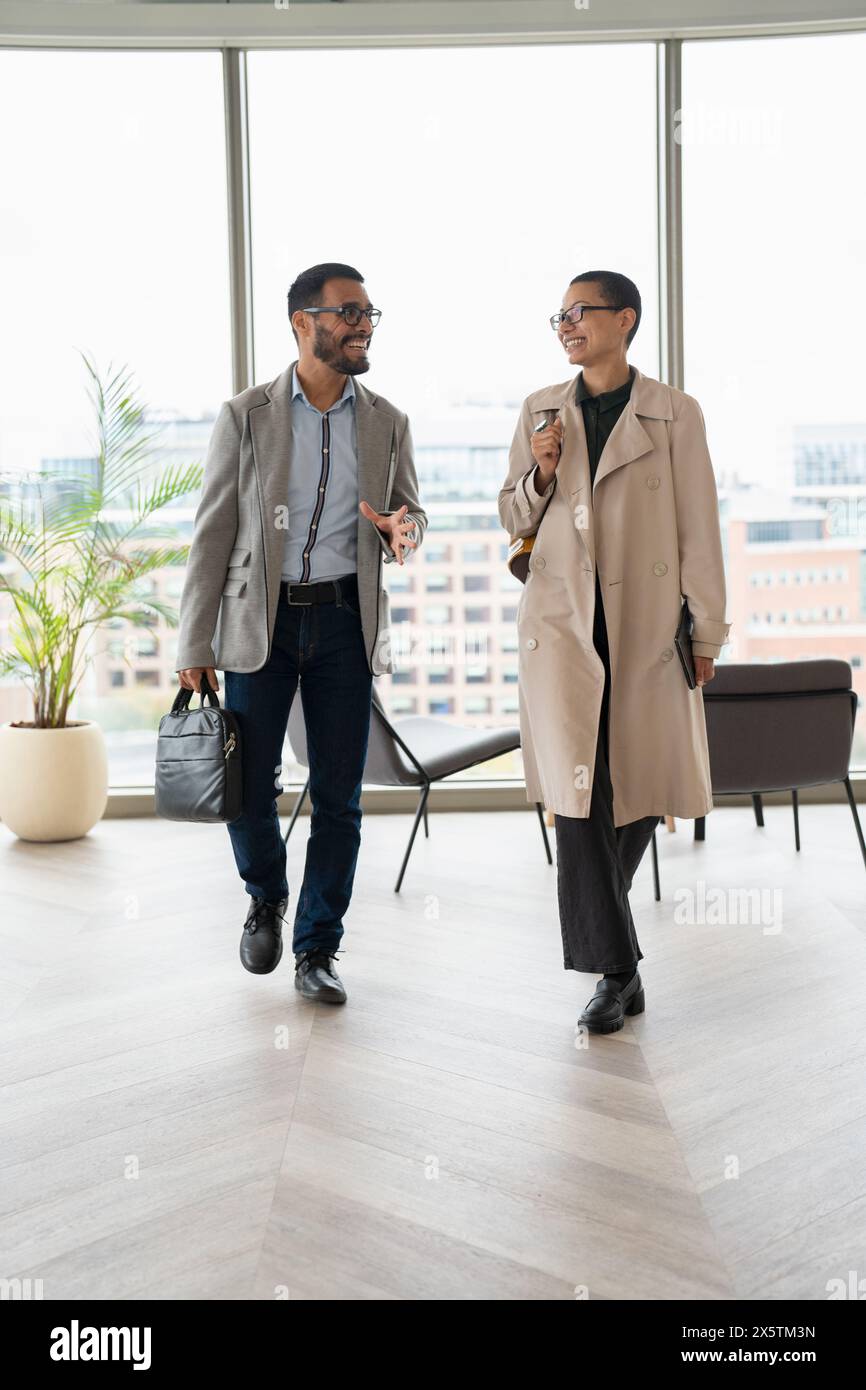 Office workers walking together in hallway Stock Photo - Alamy
