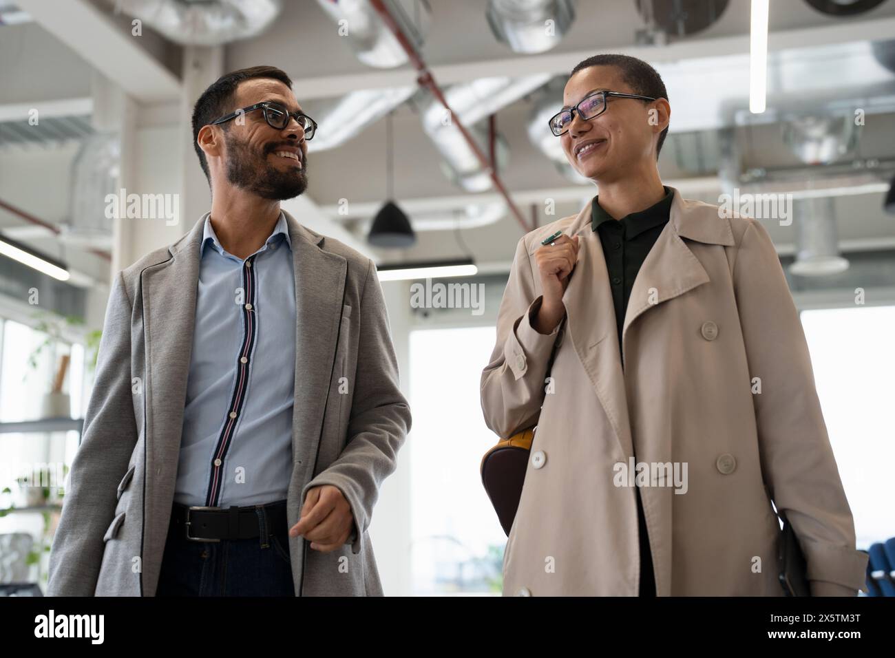 Office workers walking together in hallway Stock Photo - Alamy