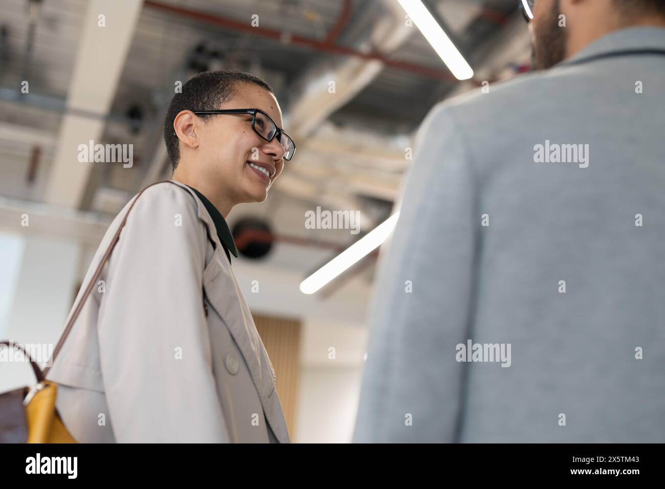 Office workers talking in hallway Stock Photo - Alamy