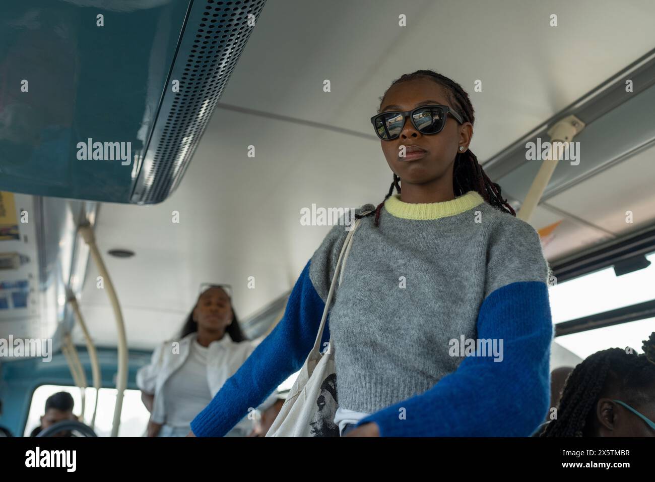 Young woman riding city bus Stock Photo - Alamy