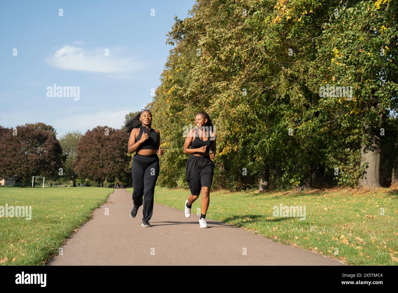Female running in park hi-res stock photography and images - Alamy