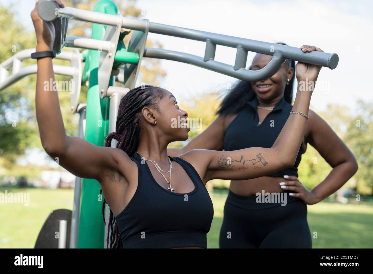 Young female friends working out in outdoor gym Stock Photo - Alamy