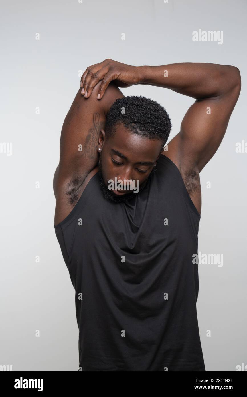 Muscular man stretching arms Stock Photo - Alamy