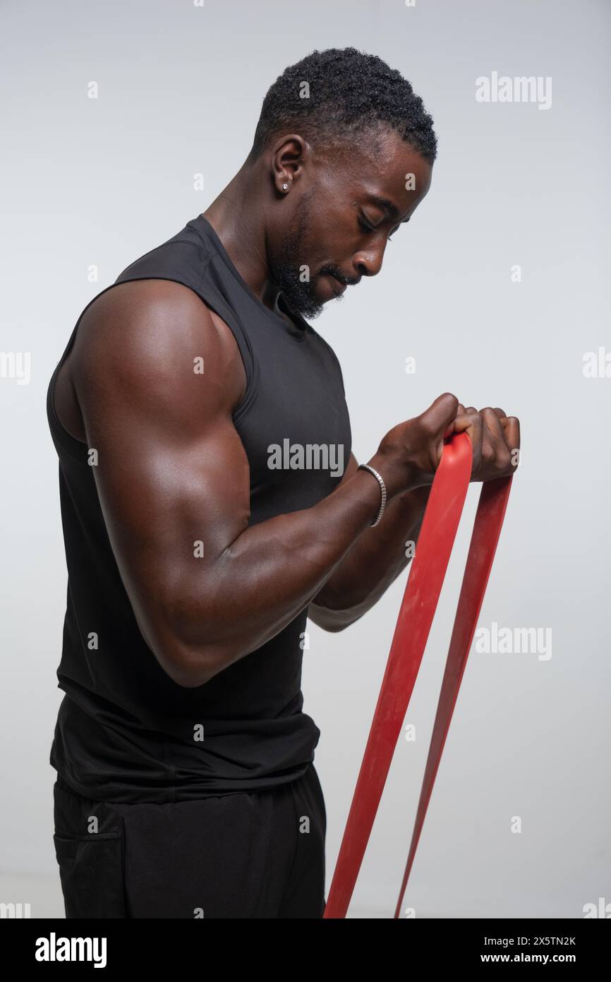Man training with resistance band Stock Photo - Alamy