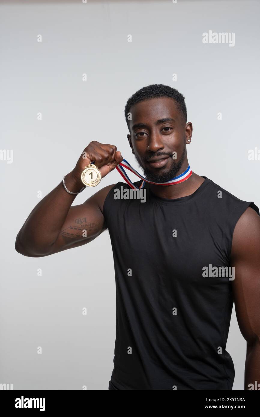 Man showing gold medal Stock Photo - Alamy
