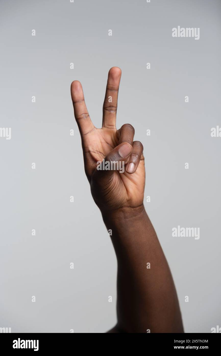 Hand showing peace sign Stock Photo - Alamy