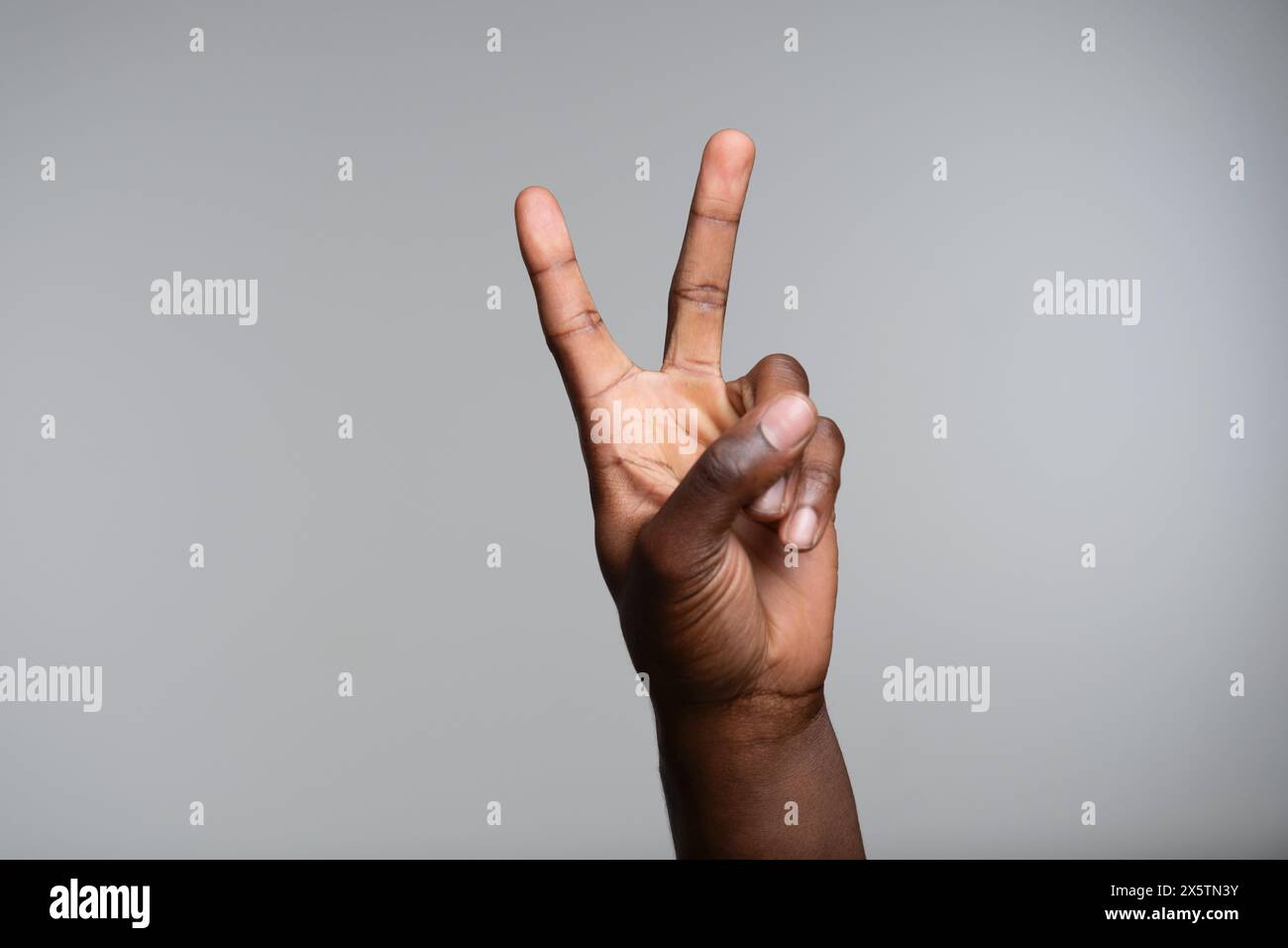 Hand showing peace sign Stock Photo - Alamy